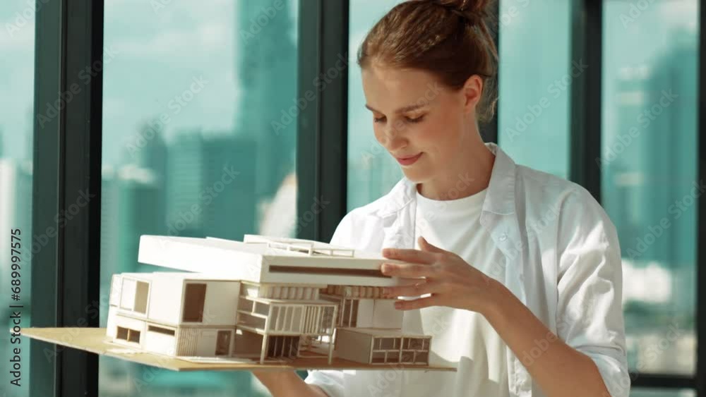 Smart happy beautiful manager check house model by turning left side ...