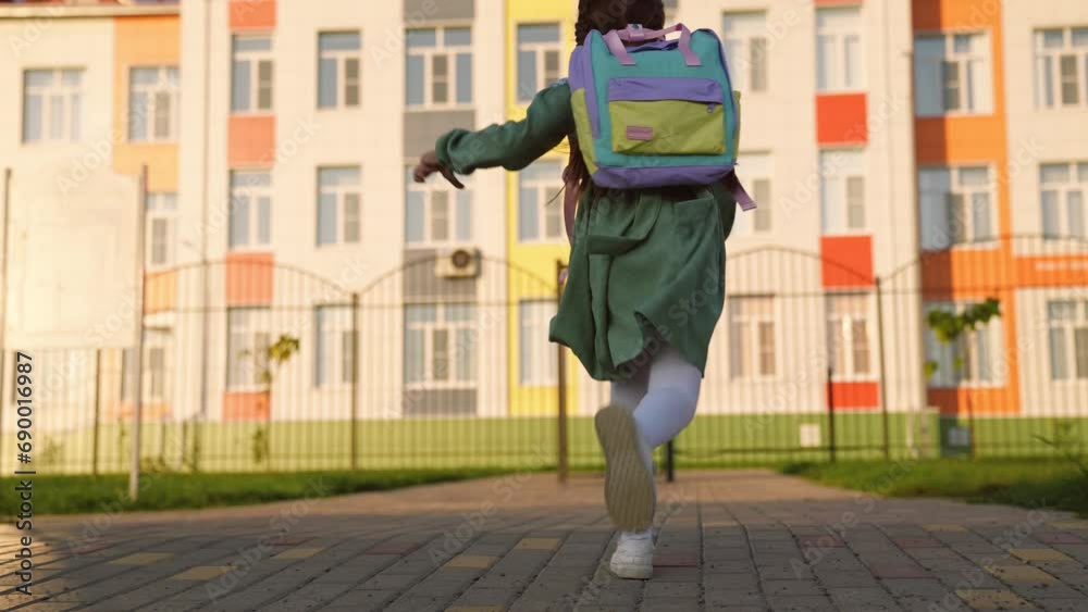 little girl with school backpack runs with her feet way to school ...