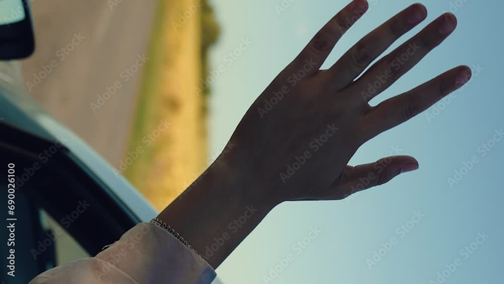 girl rides car with her hand out window, happy family enjoying having ...