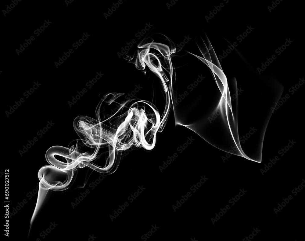 Abstract white puffs of smoke swirl overlay on black background ...