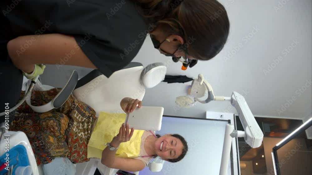 Vertical slow motion of a happy female latin patient admiring her new ...