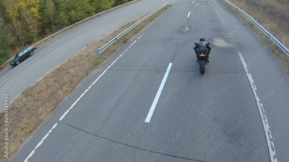 Camera moving around of biker riding on modern sport motorbike at ...
