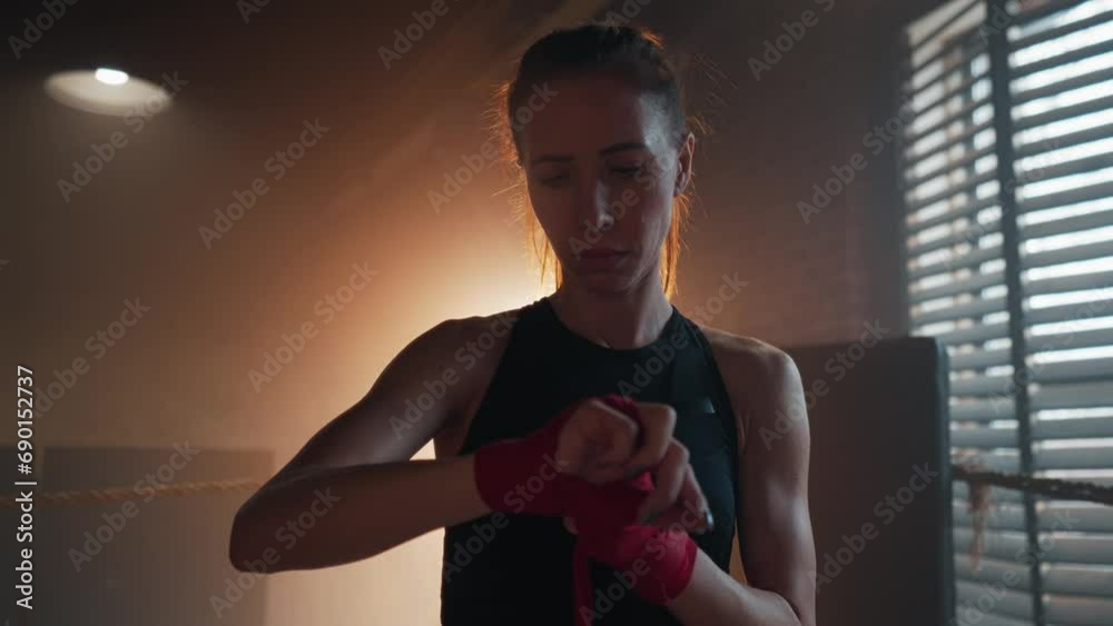 Woman fighter boxer wraps hands with boxing bandage. Kickboxing ...