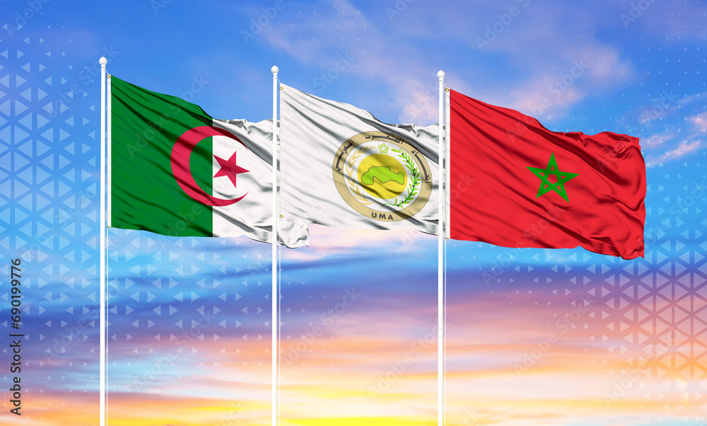flags of morocco, algeria and Arab Maghreb Union.on flagpoles and blue ...