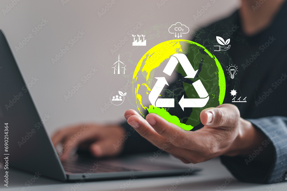 Businessman Holding Global Recycle Symbol For Circular Economy To