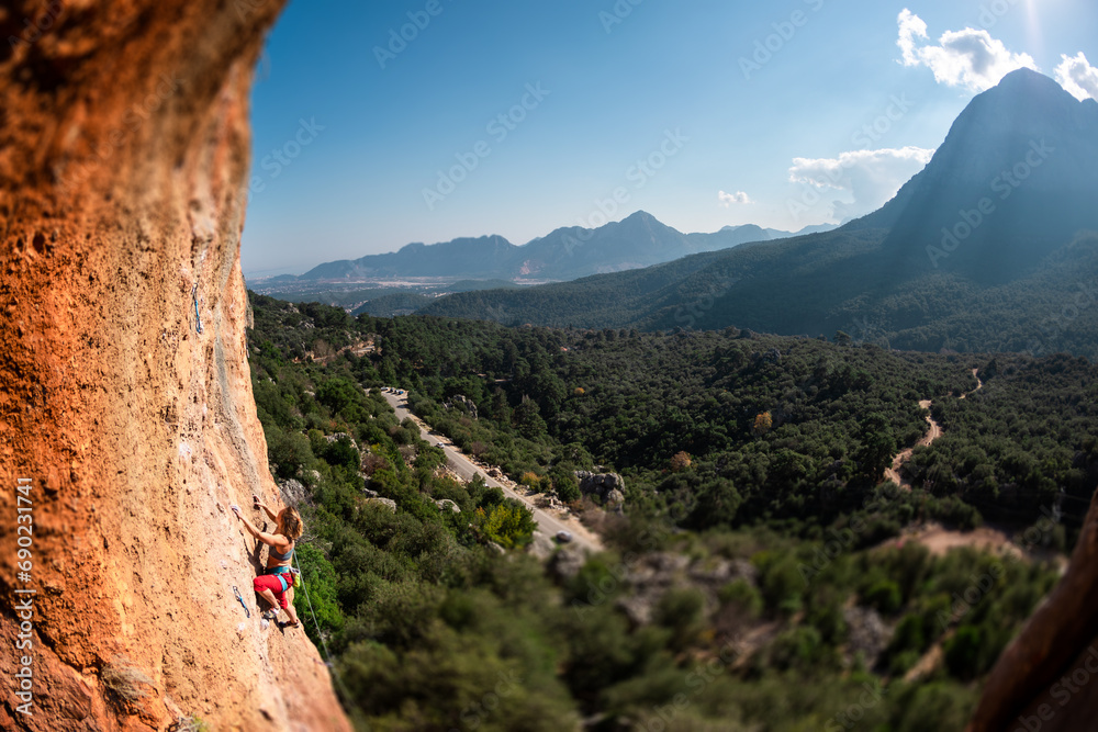 The girl climbs the rock. Climber trains on natural terrain. Extreme ...