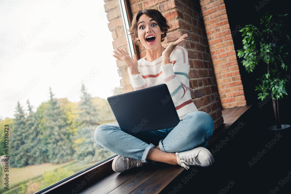 Full size portrait of astonished pretty girl sit wooden window sill ...