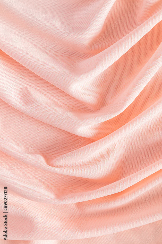 Soft pleats of peach colored satin textiles. Luxury abstract textile ...
