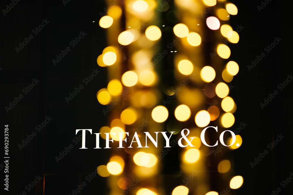 Tiffany & Co Logo Sign with Blurred Lights in Foreground Stock Photo ...