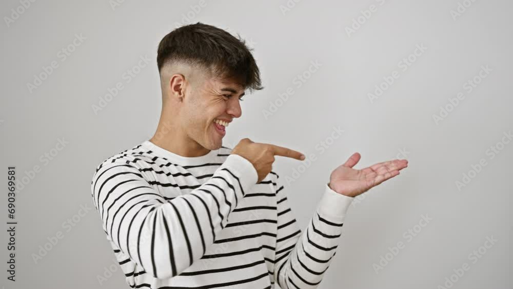 Delighted young hispanic man in stripes, presenting with amazed smile ...