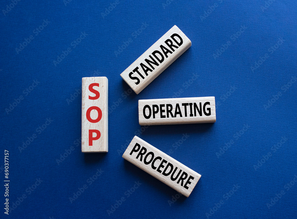 SOP - Standard Operating Procedure symbol. Wooden blocks with word SLA ...