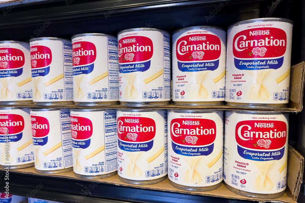 Cans of Nestle Carnation Brand Evaporated milk for sale at a local ...