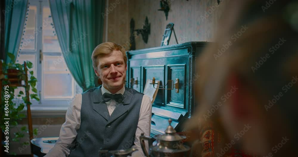 Englishman drinking tea with wife in old house in 19th century, vintage ...