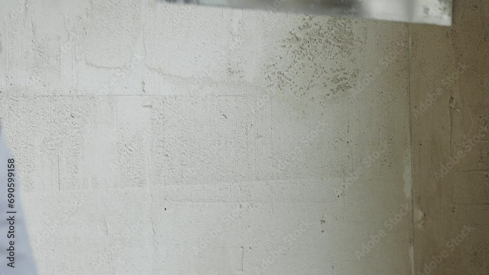 Unrecognisable professional repairman workman is levelling concrete ...