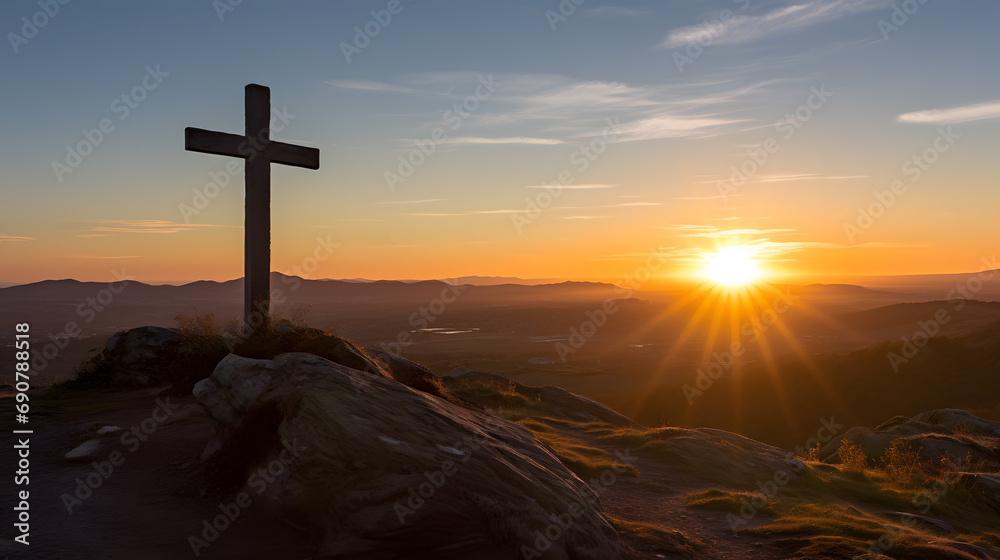 Christian cross on top of a hill facing the rays of a new dawn rising ...