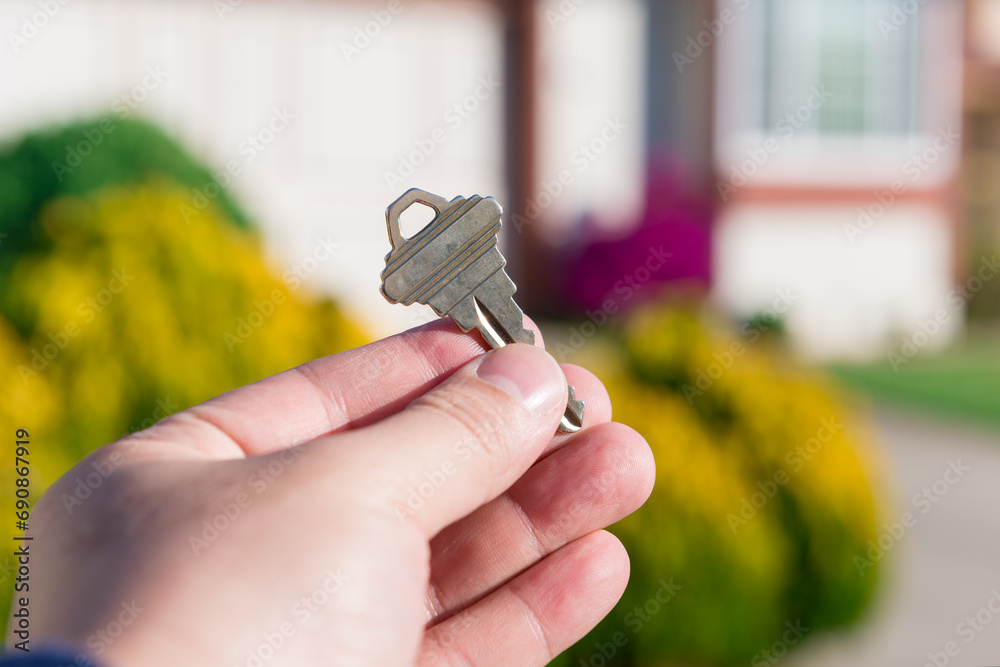 handing key in a house background Stock Photo | Adobe Stock