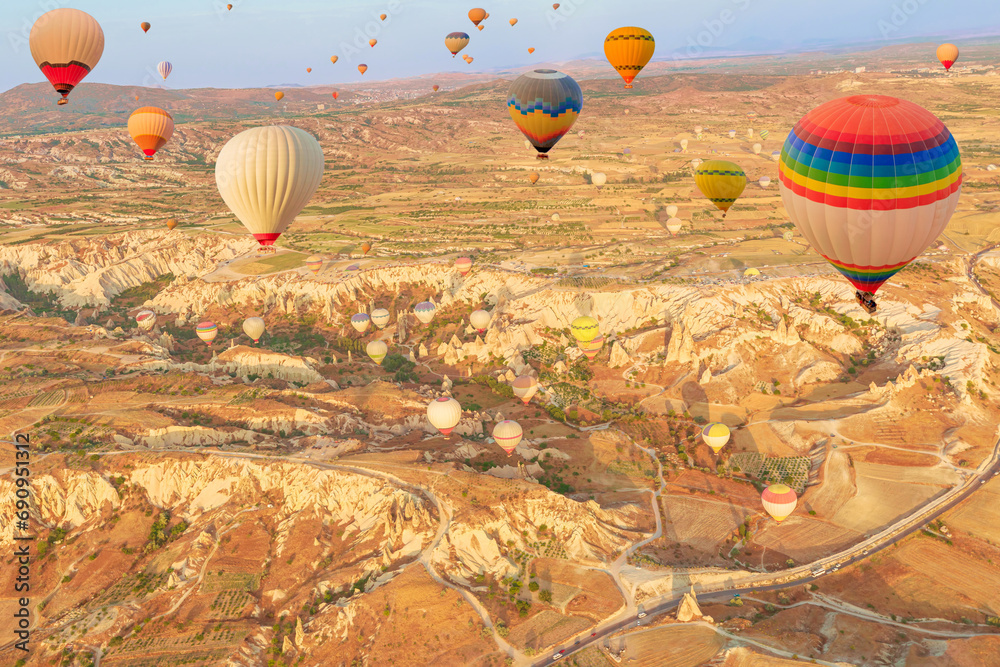 At dawn, a multitude of Cappadocia's vibrant air balloons ascend ...