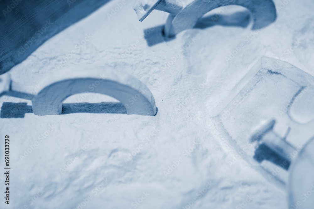 Objects printed on a 3D printer from powdered polyamide lying in white ...