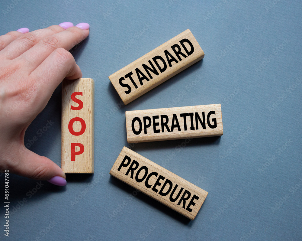 SOP - Standard Operating Procedure symbol. Wooden blocks with word SLA ...