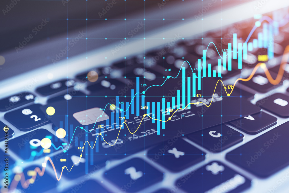 Close up of laptop keyboard and bank card with glowing candlestick ...