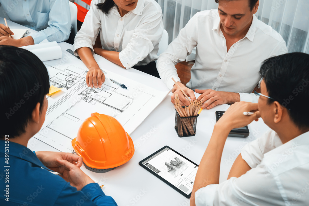Diverse group of civil engineer and client working together on ...