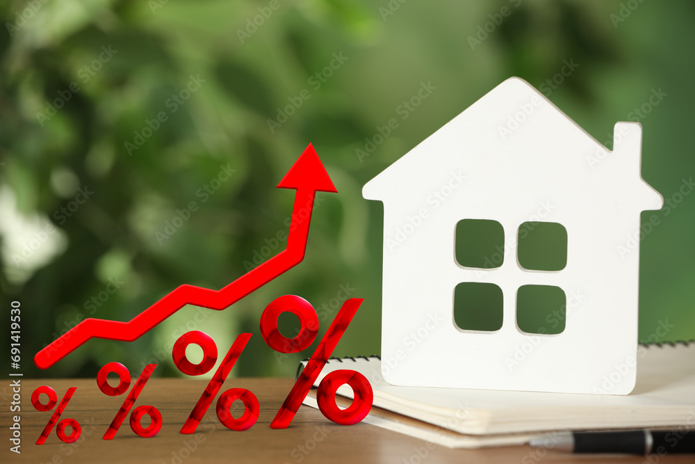 Mortgage rate rising illustrated by percent signs and upward arrow ...