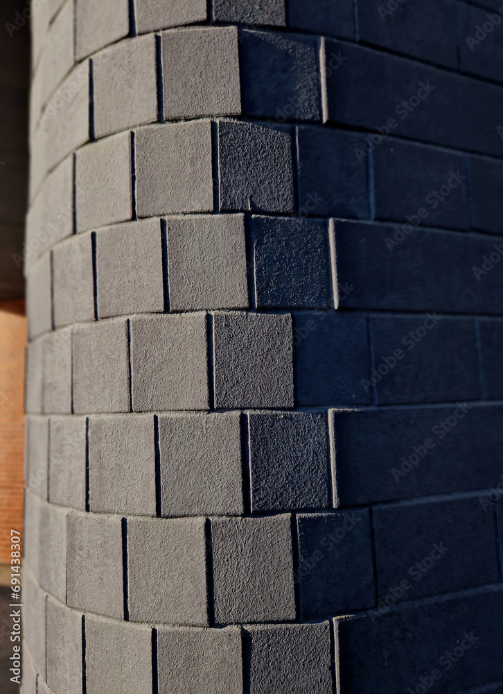 round corner of the building lined with tiles in an arch. the shadows ...