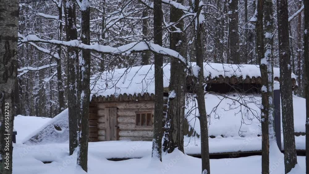Vidéo Stock A dugout built of logs, the scene in a forest in wintertime ...