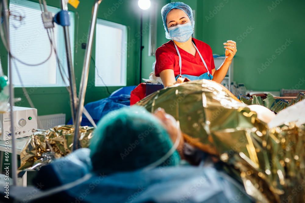 Preparation for the child birth. Young female midwife in uniform ...