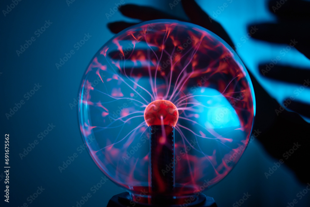 plasma ball. Hands holding plasma light ball. Plasma ball light ray ...