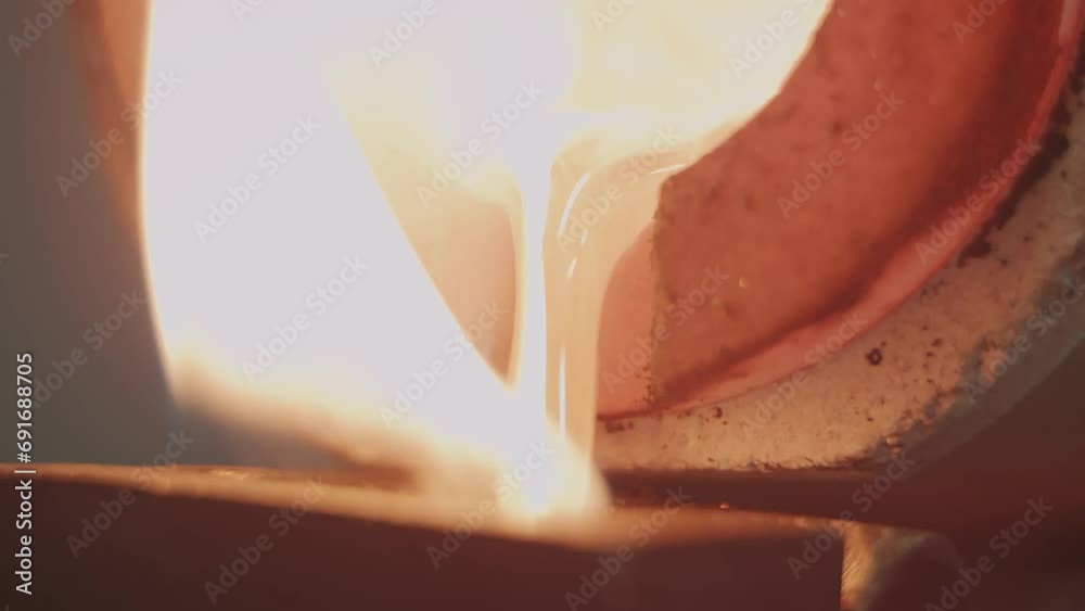 Molten Gold being poured into Ingot moulds. Molten Gold being poured ...