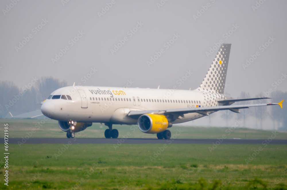 Vueling com Airbus A320 Taxiing on a Slightly Foggy Shiphol Airport ...
