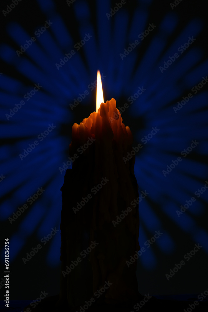 Candle flame with exploding flammable liquid sprayed onto flame ...