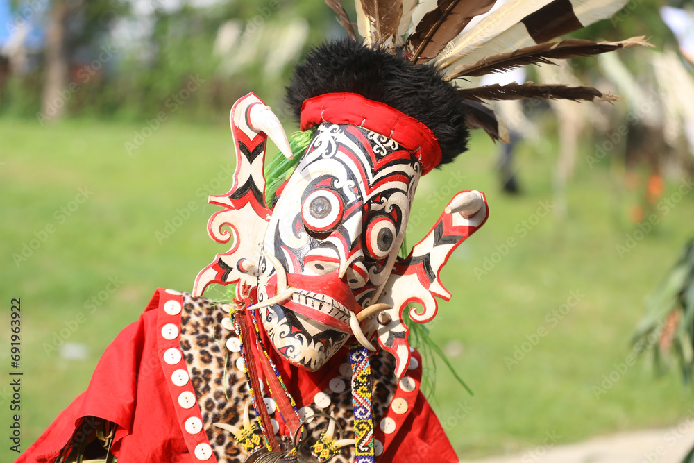 the portrait of hudoq dancers marching in order to perform sacred ...