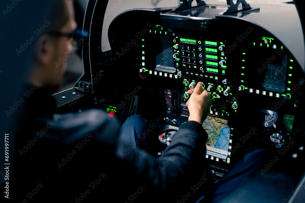 close-up hand of the pilot captain presses the buttons on the control ...