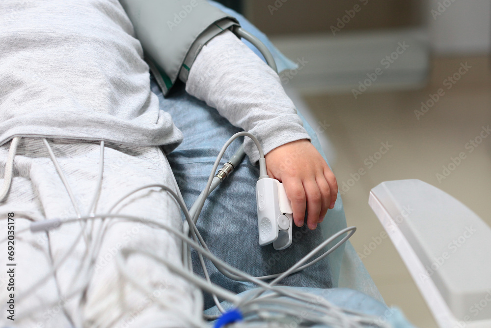 Measurements of oxygen and pulse in a child. Pulse oximeter on the ...
