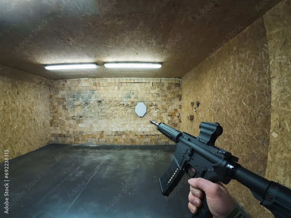 Shooting from an M4 rifle at a shooting range at targets, first-person ...