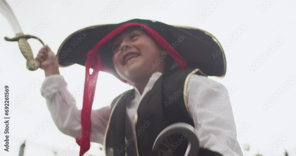 Outdoor, pirate and child with costume, excited and jumping with ...