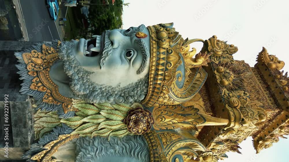 Vertical aerial view of the incredible and detailed statue in Benoa on ...
