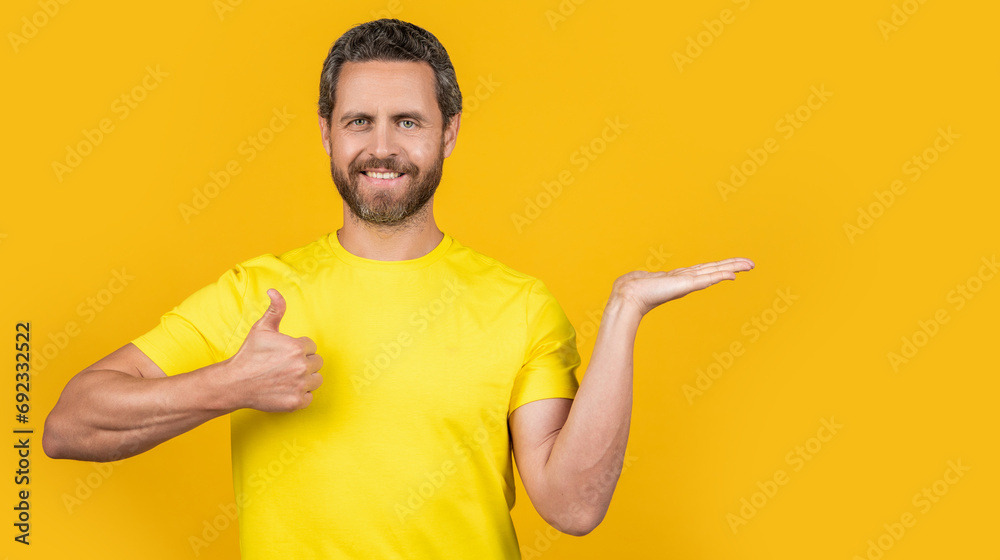 happy man presenting advertisement on background, thumb up. man ...