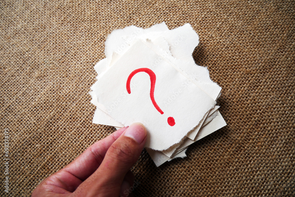Question mark paper. Torn paper holding hand with question mark on ...