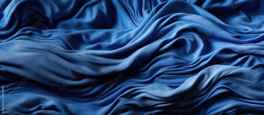 background, a rumpled blue fabric, resembling a wave, served as ...