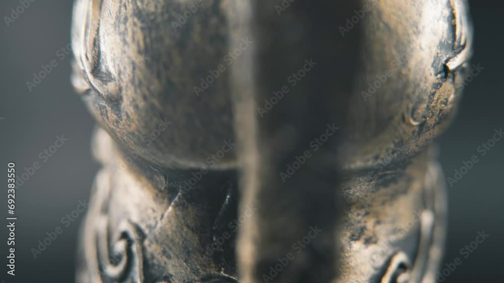 A close up macro detailed slow tilt up shot from behind of a spartan ...