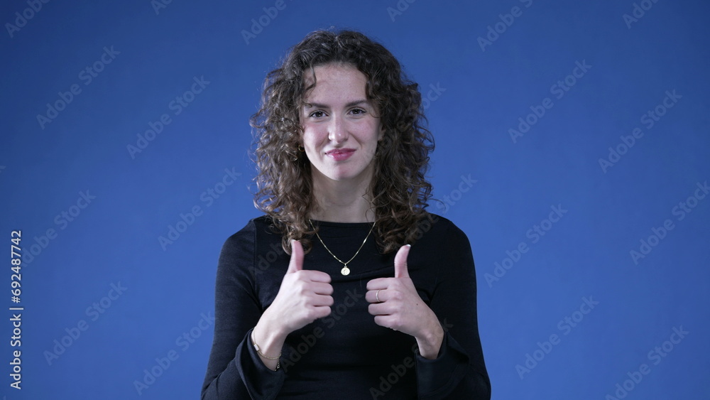 Woman congratulating herself by clapping hands and pointing at herself ...