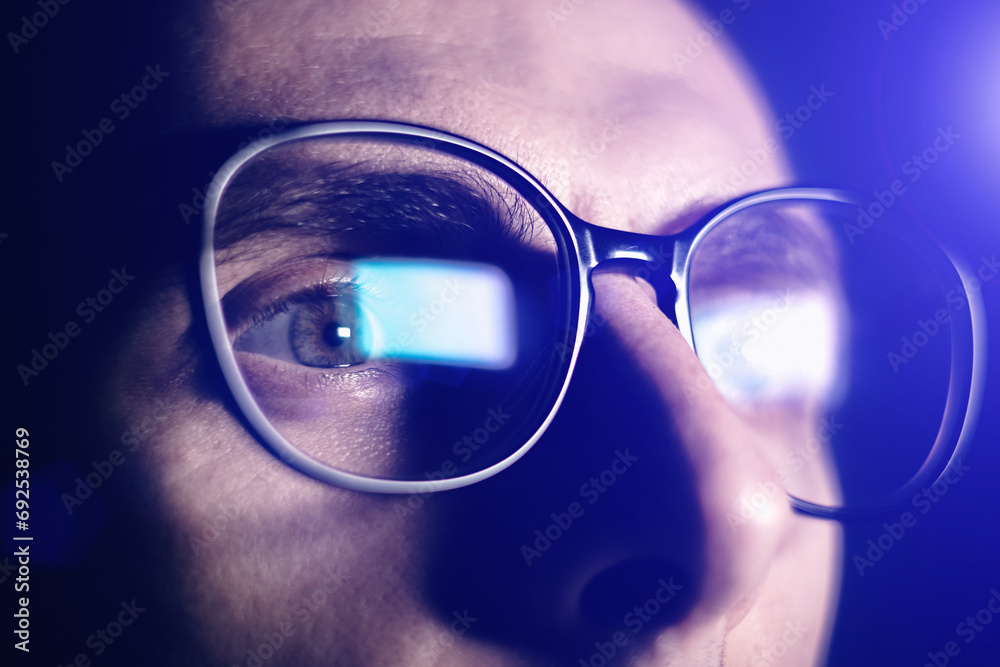 Man works on internet. Reflection at the glasses from laptop..Close up ...
