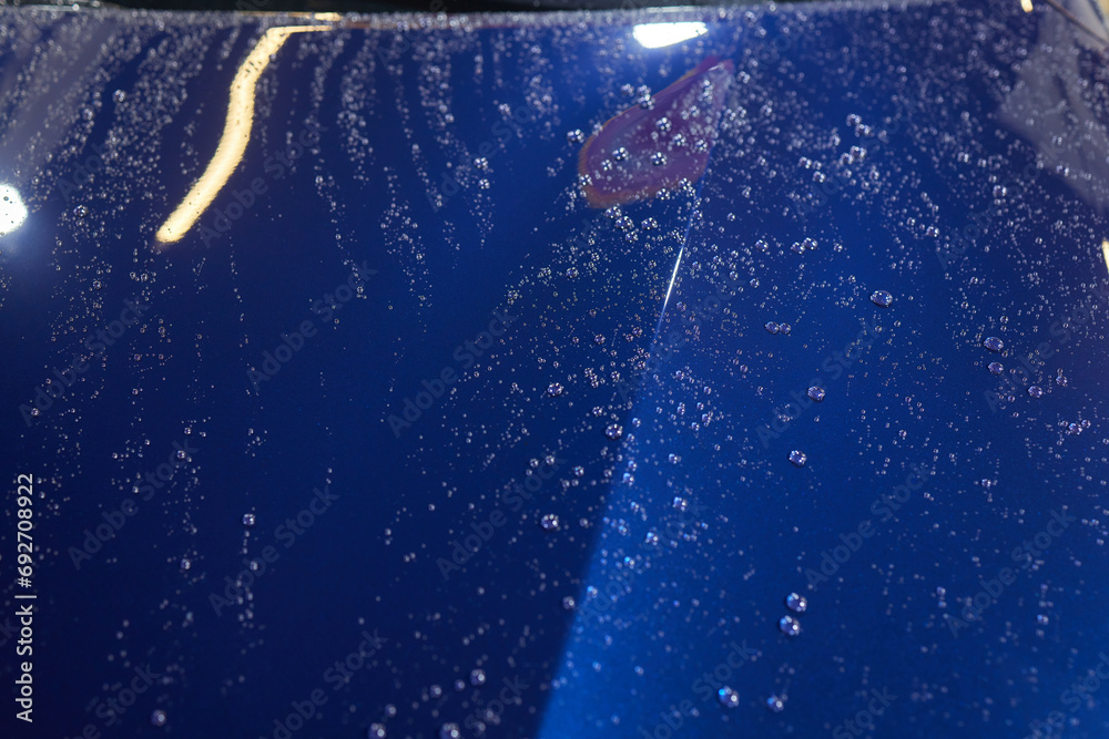 Man worker drying car on wash. Service car wash express. Worker uses ...