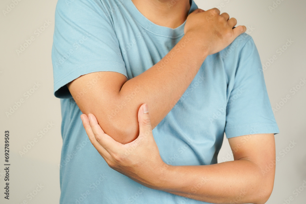 Health concept, person with elbow pain, man holding hand on elbow with ...