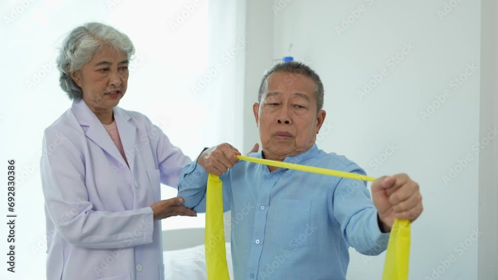 Caregiver, physical therapist, elderly doctor helping elderly Asian ...
