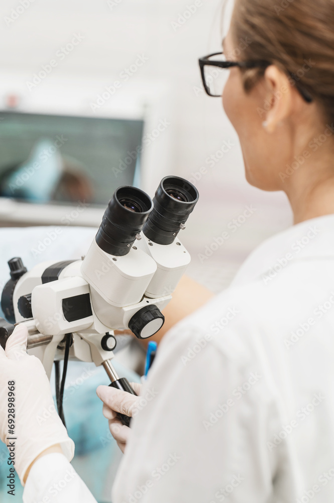woman doctor look microscope at gynecologist's appointment. Female ...