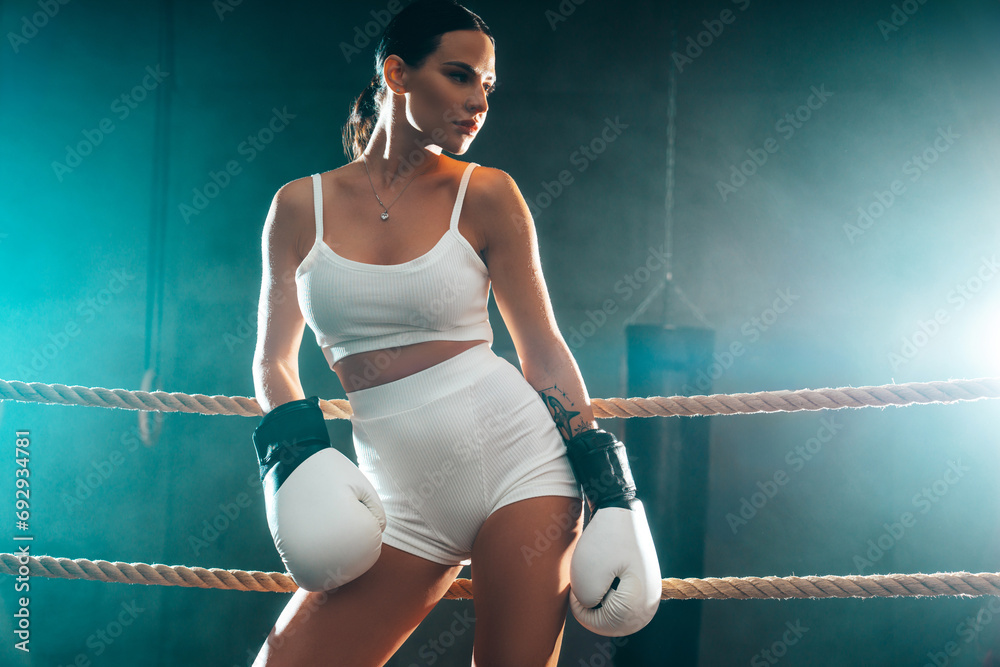 Cinematic portrait of sexy fighter woman in a boxing ring. Model ...